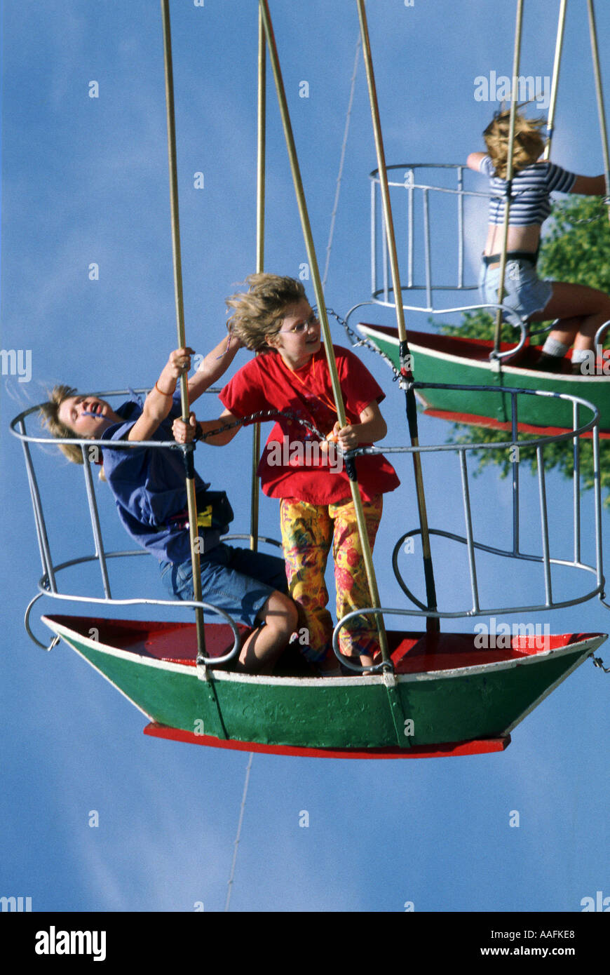 children playing on swing boat at a fair Stock Photo - Alamy