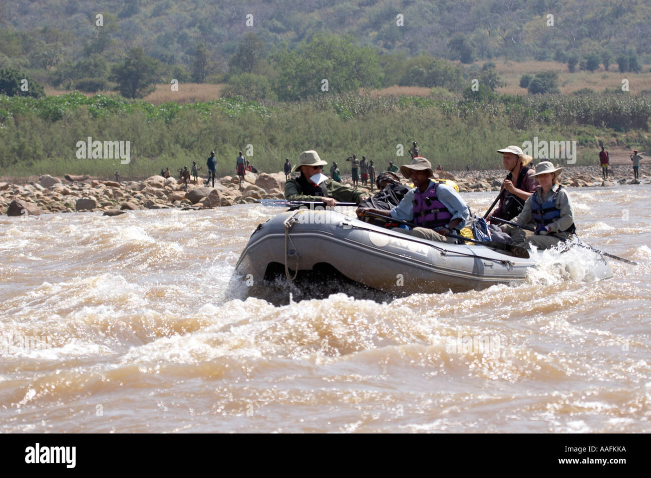 People white water rafting through cataracts or rapids on rough Blue ...