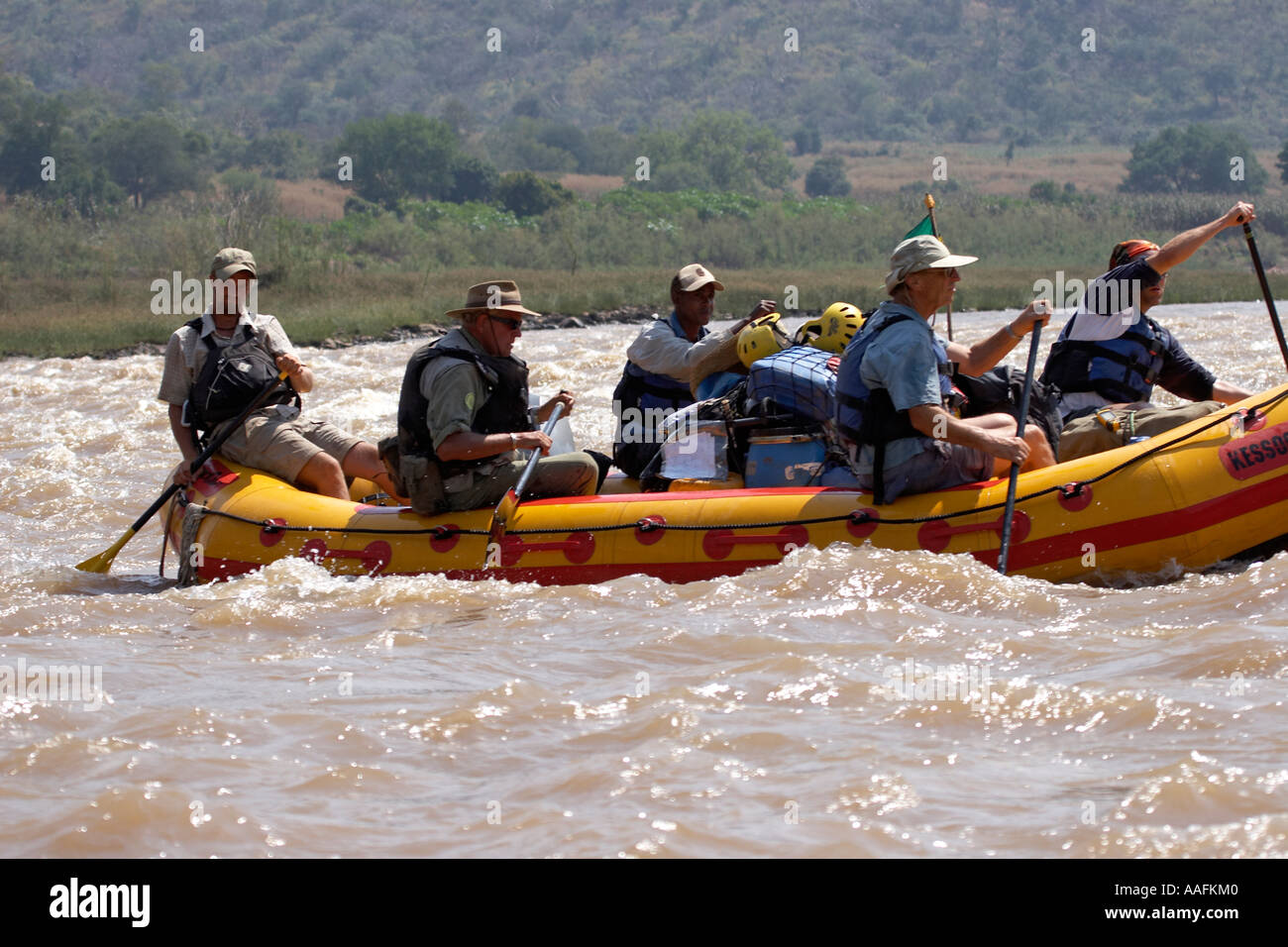 People white water rafting through cataracts or rapids on rough Blue ...
