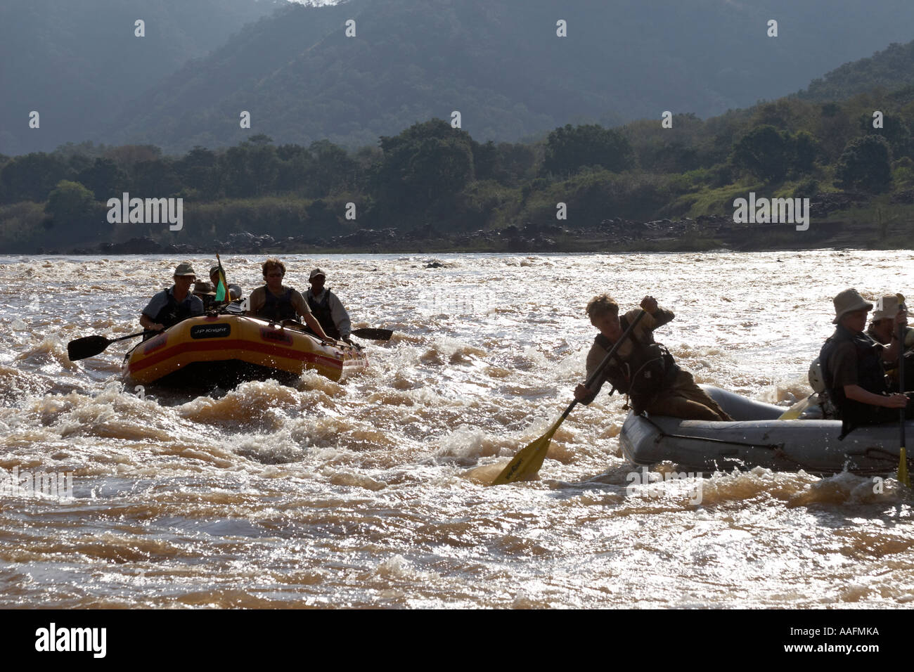 People white water rafting through cataracts or rapids on rough Blue ...