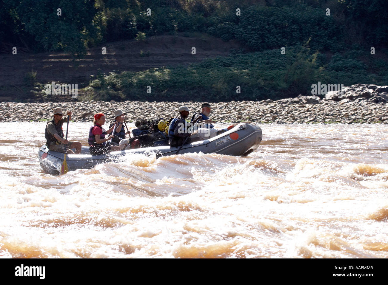 People white water rafting through cataracts or rapids on rough Blue ...