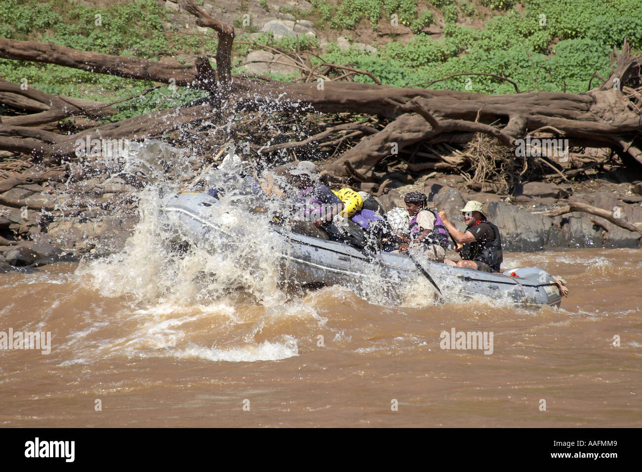 People white water rafting through dramatic cataracts or rapids on ...