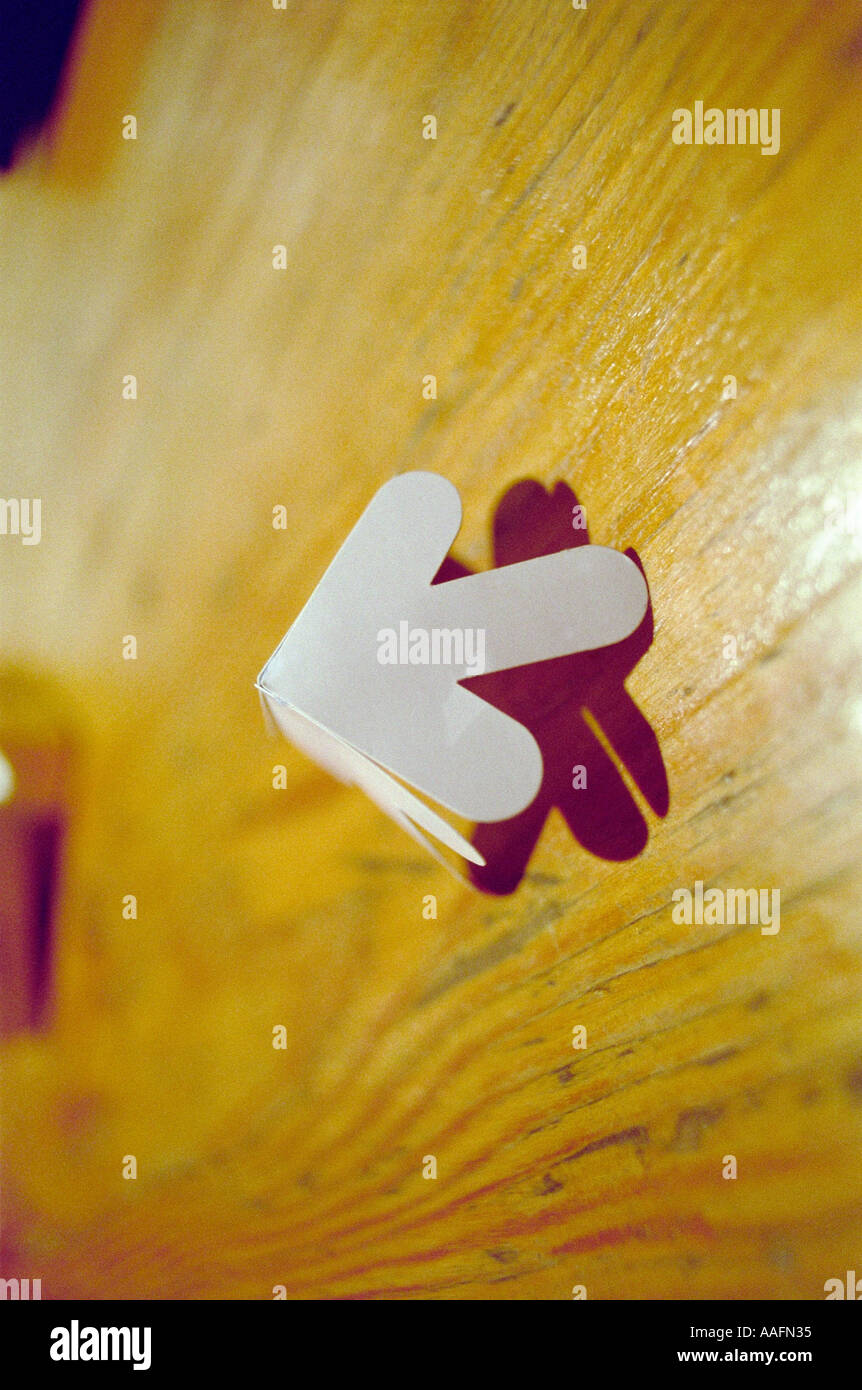 An arrow made of paper pointing in a direction from the table Stock ...