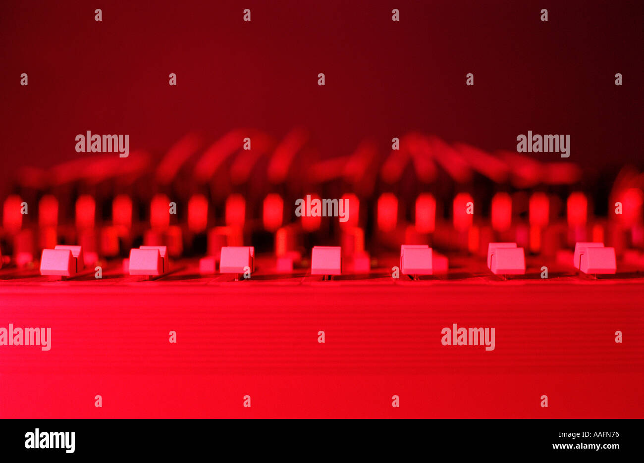 A recording desk in a recording studio with red light Stock Photo - Alamy