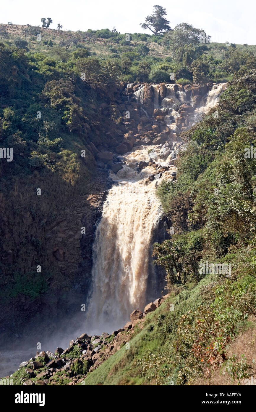 Waterfall with red brown water pouring over the escarpment near Kuch ...