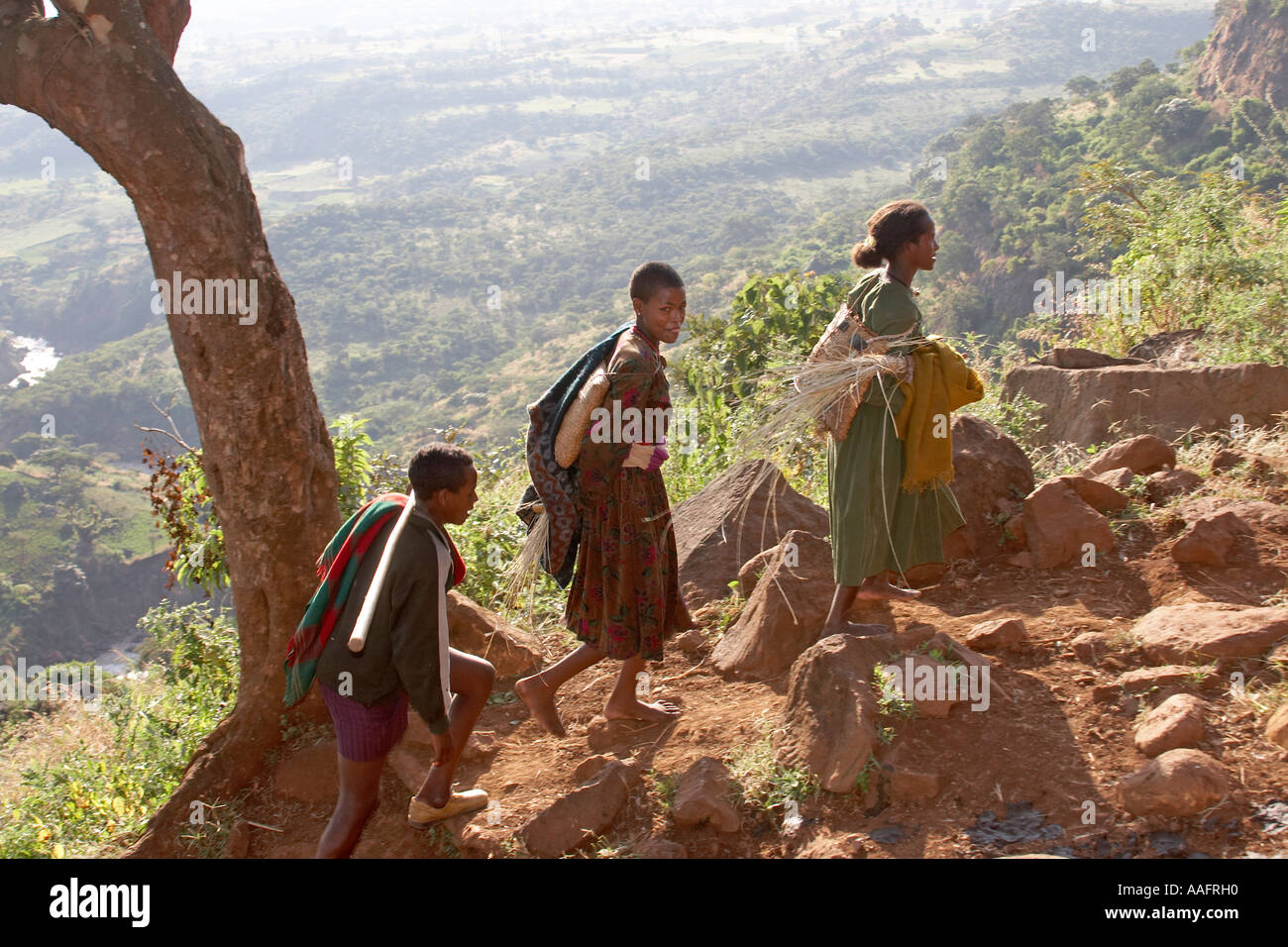 Local people walking up escarpment near Kuch Stock Photo - Alamy