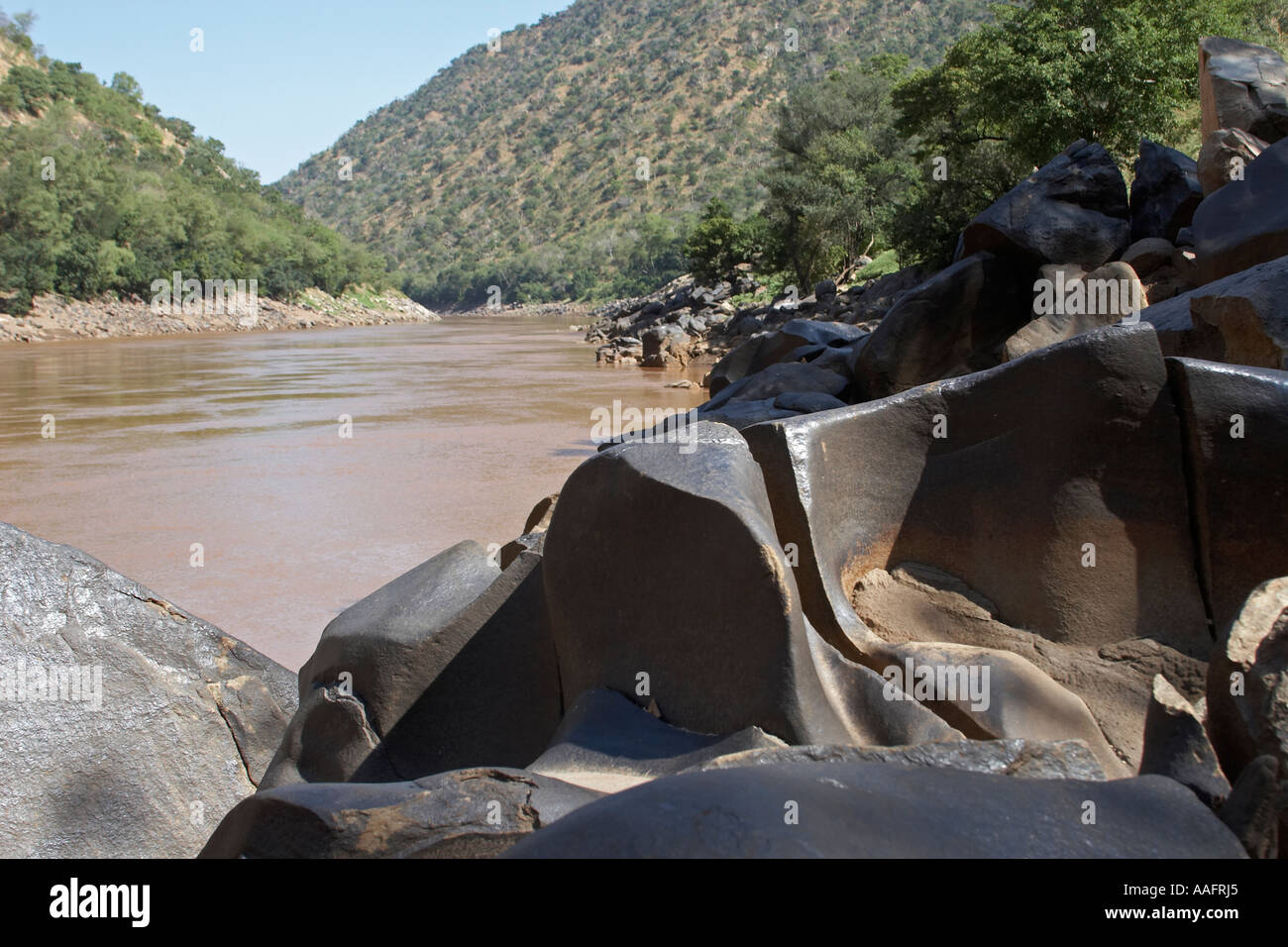Dark volcanic rocks in Black Gorge of Blue Nile river near Bure Bridge ...