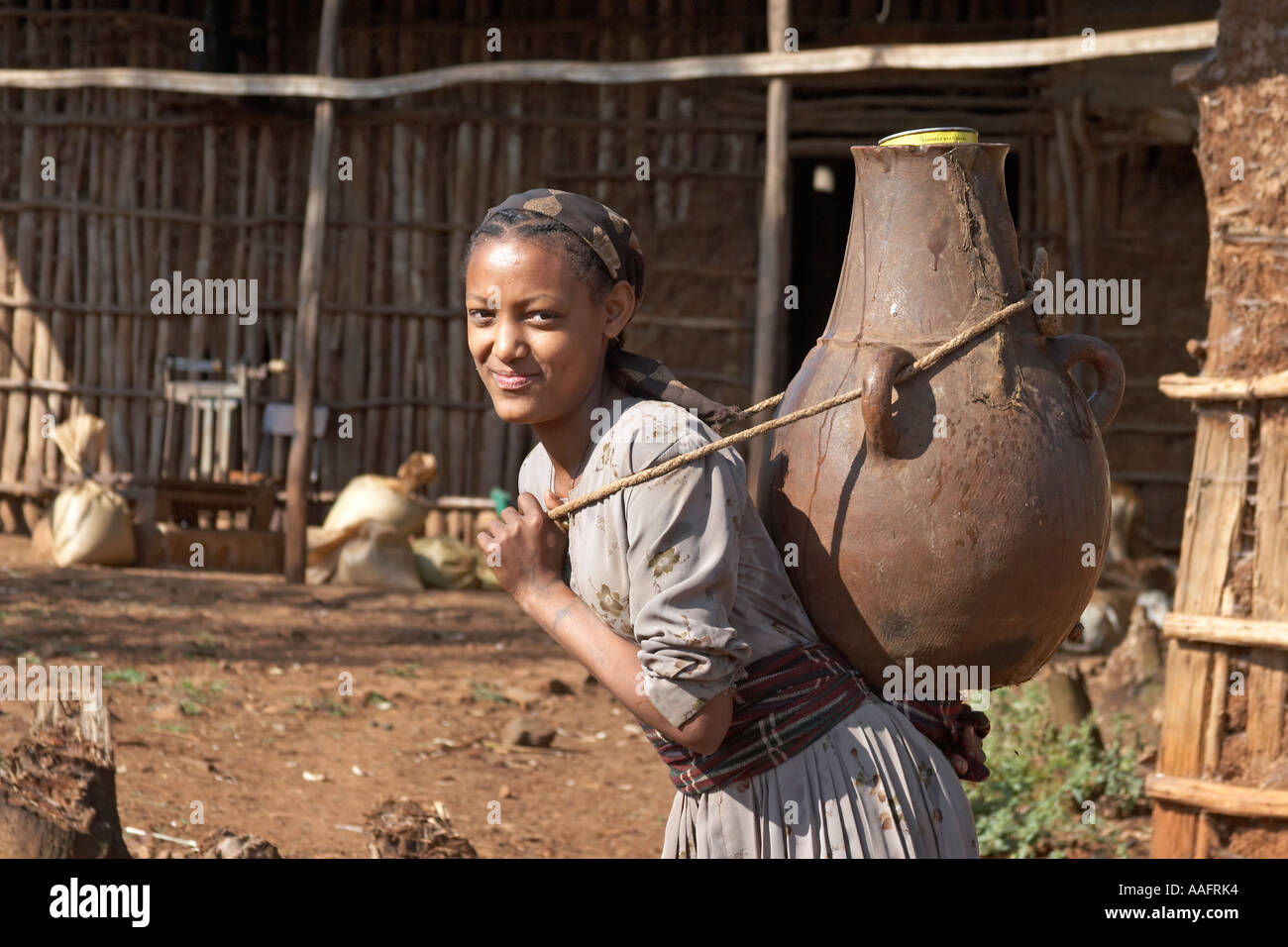 Woman carrying water jars hi-res stock photography and images - Alamy