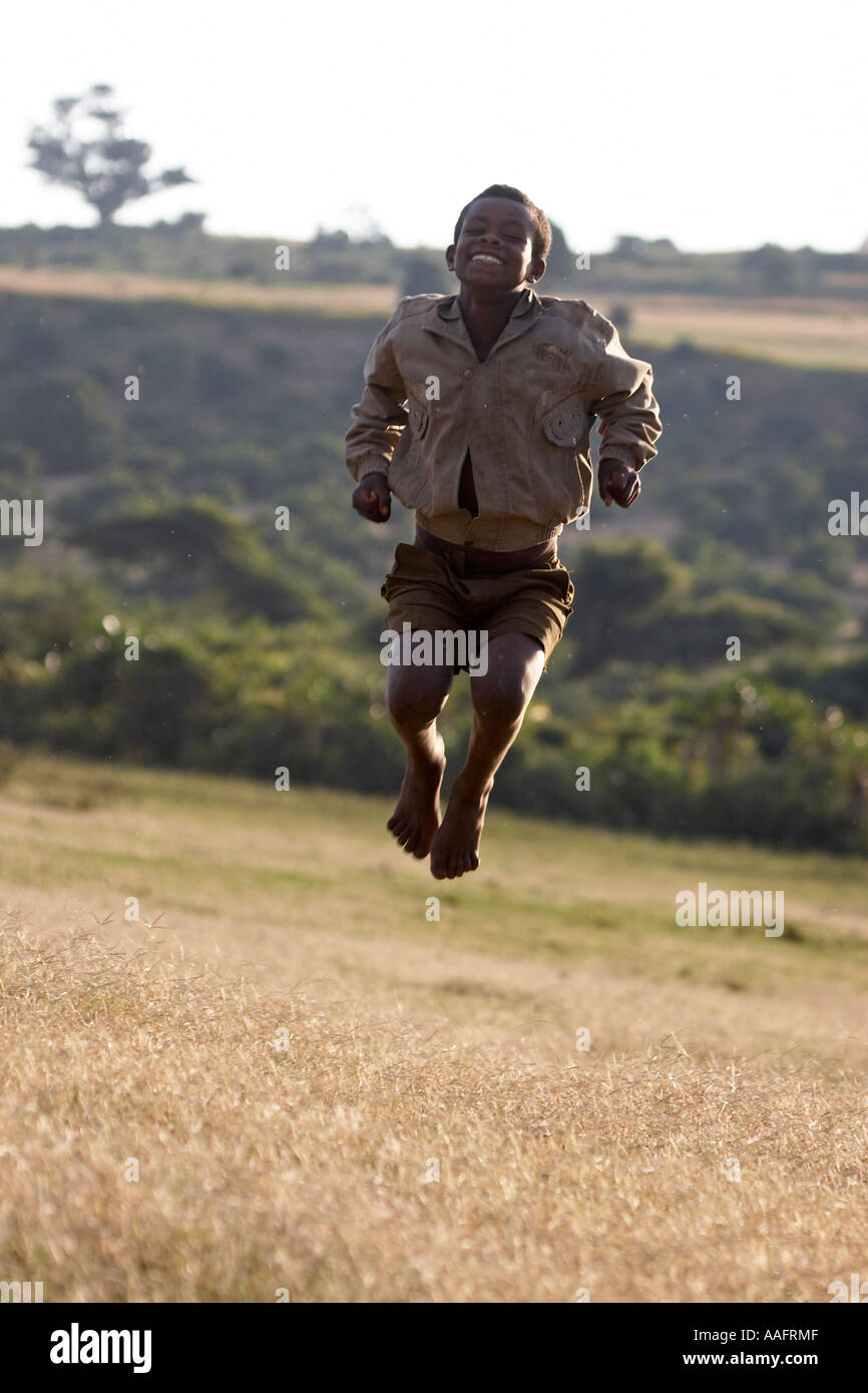 Young boy child jumping in the air outside in fields near Kuch Ethiopia ...