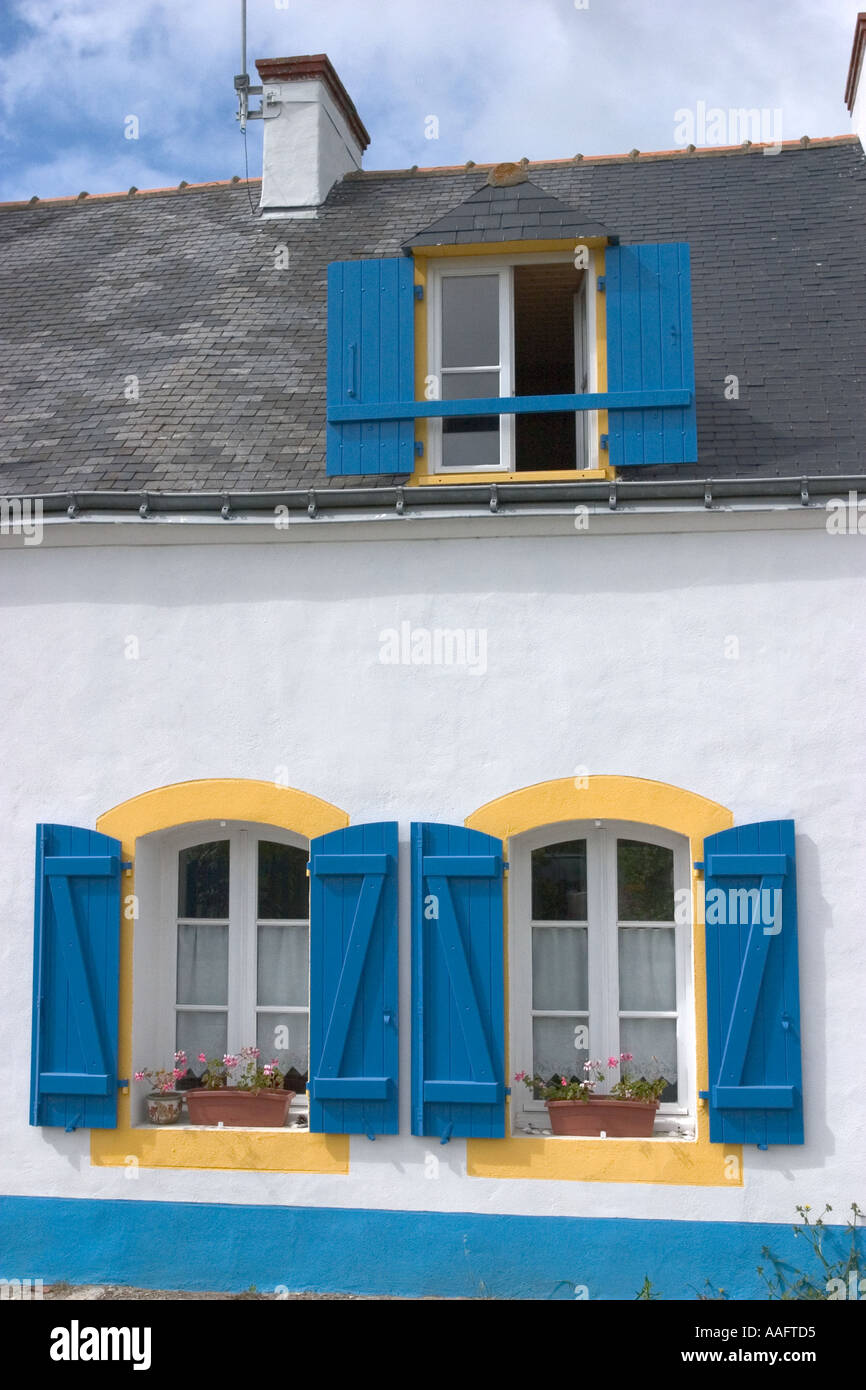 wall frontage of house with blue and yellow windows and window in belle ...