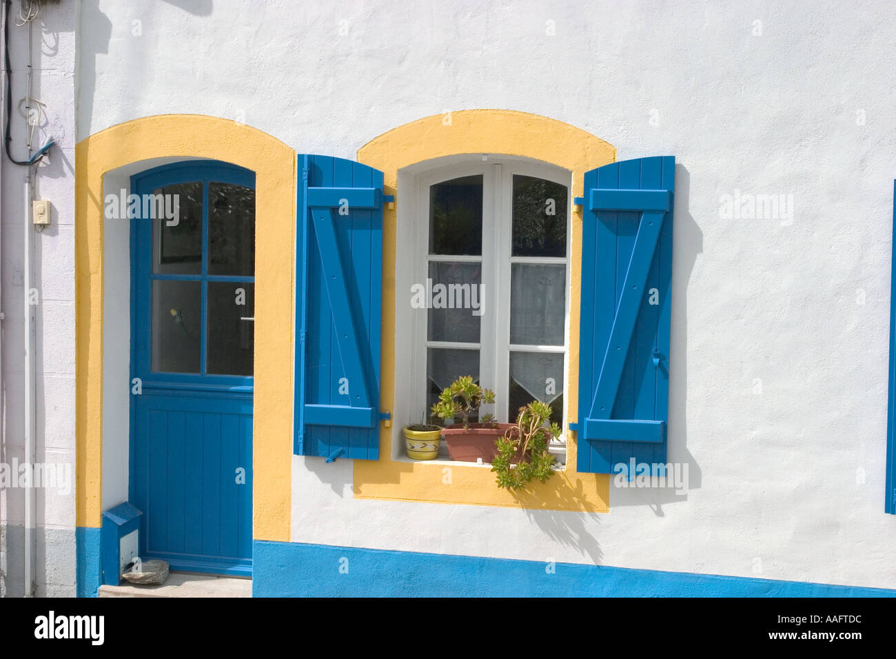 wall frontage of house with blue and yellow door and window in belle ...