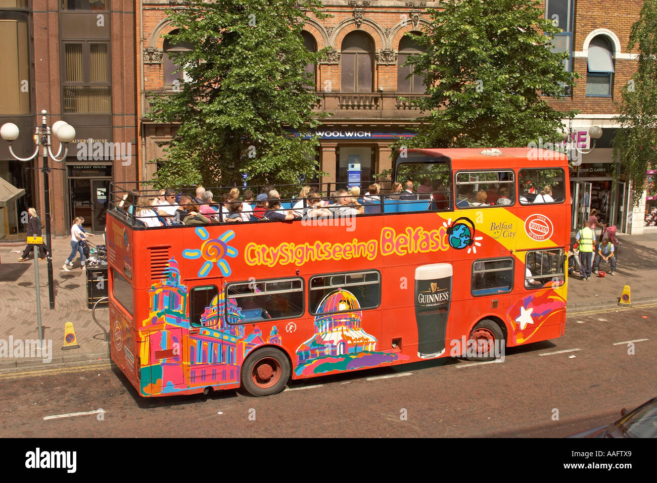 City Sightseeing red double decker bus with tourists on High Street ...
