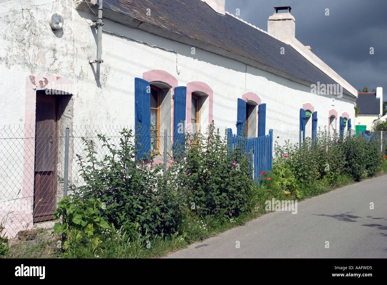 wall frontage of house with blue and white door and window in belle ile ...