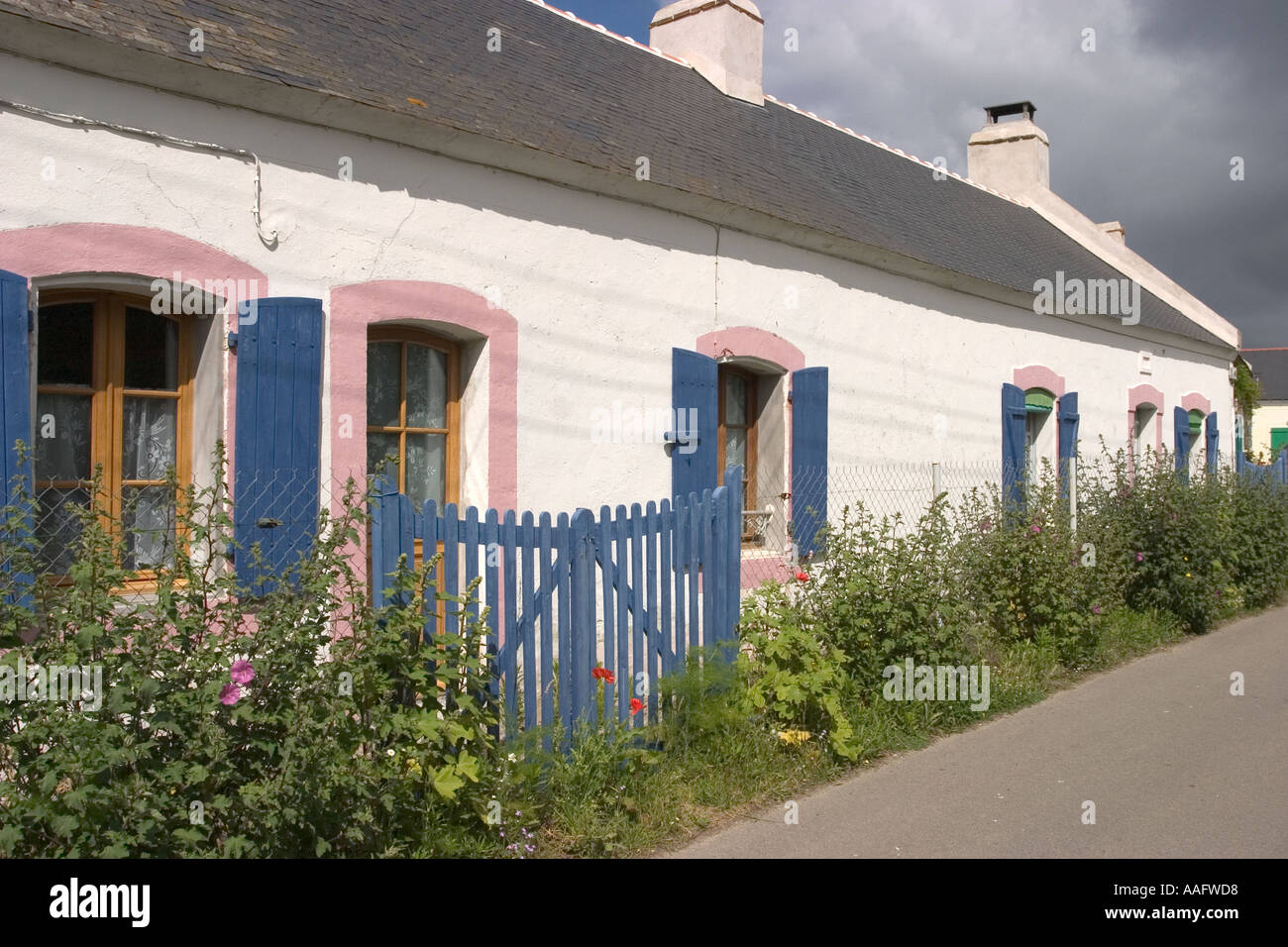 wall frontage of house with blue and yellow door and window in belle ...