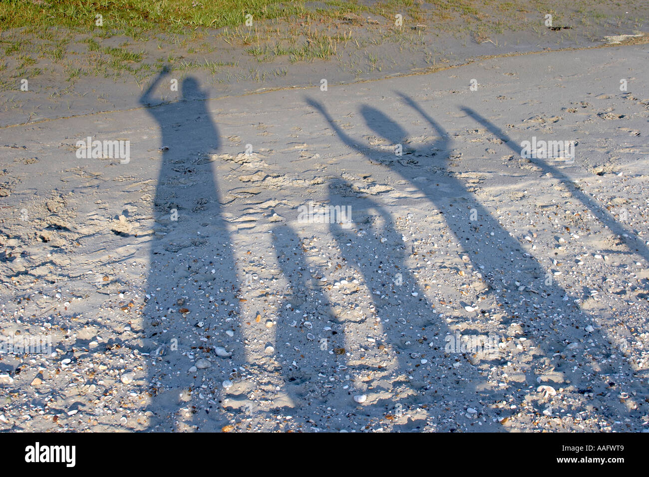 Shadows of family people waving at West Wittering Hampshire England UK ...