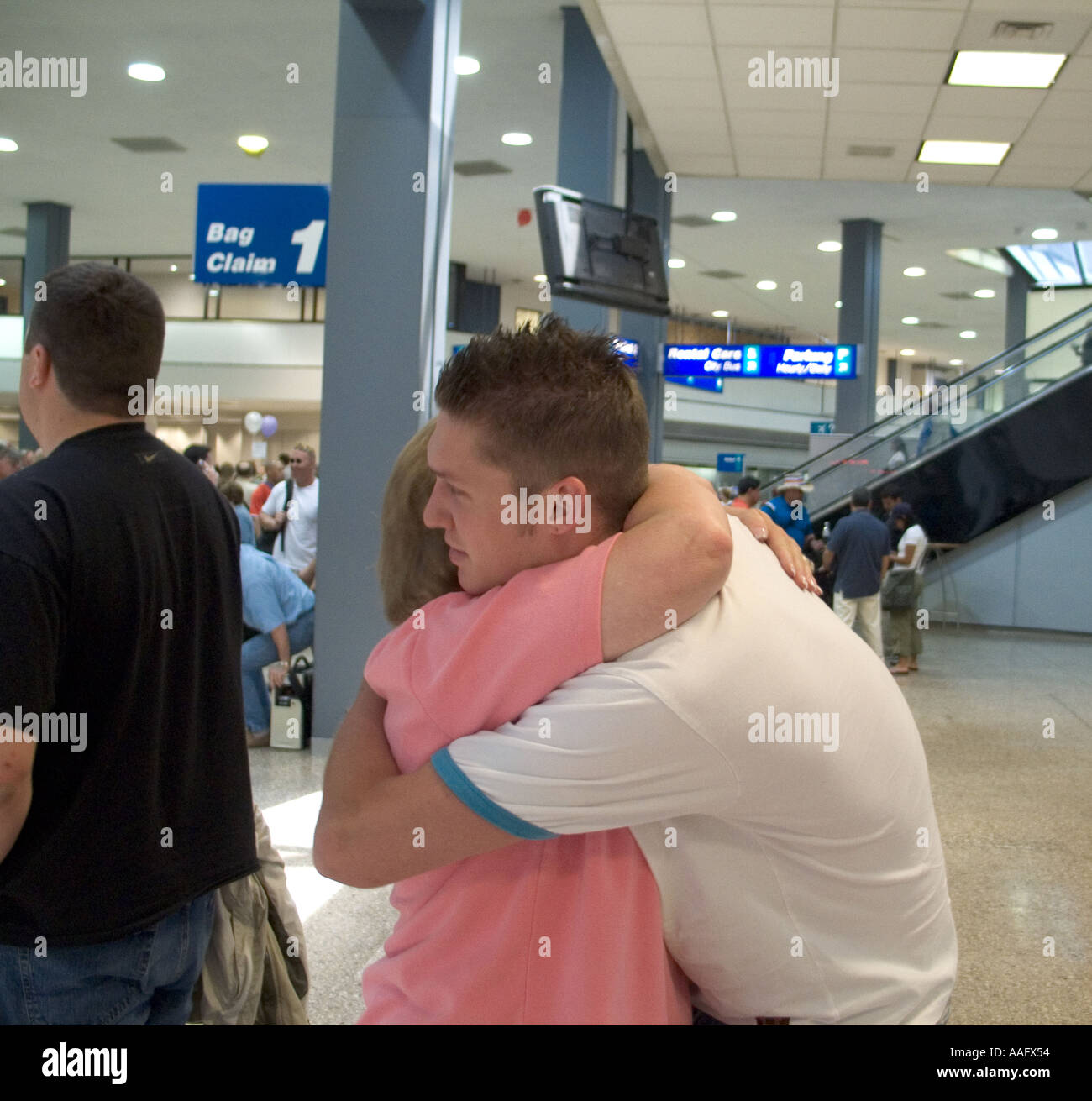 Young man hugging his mother after arriving at the Salt Lake City ...