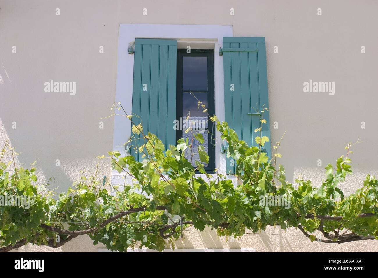 wall frontage of house with blue windows and shutters with open ...