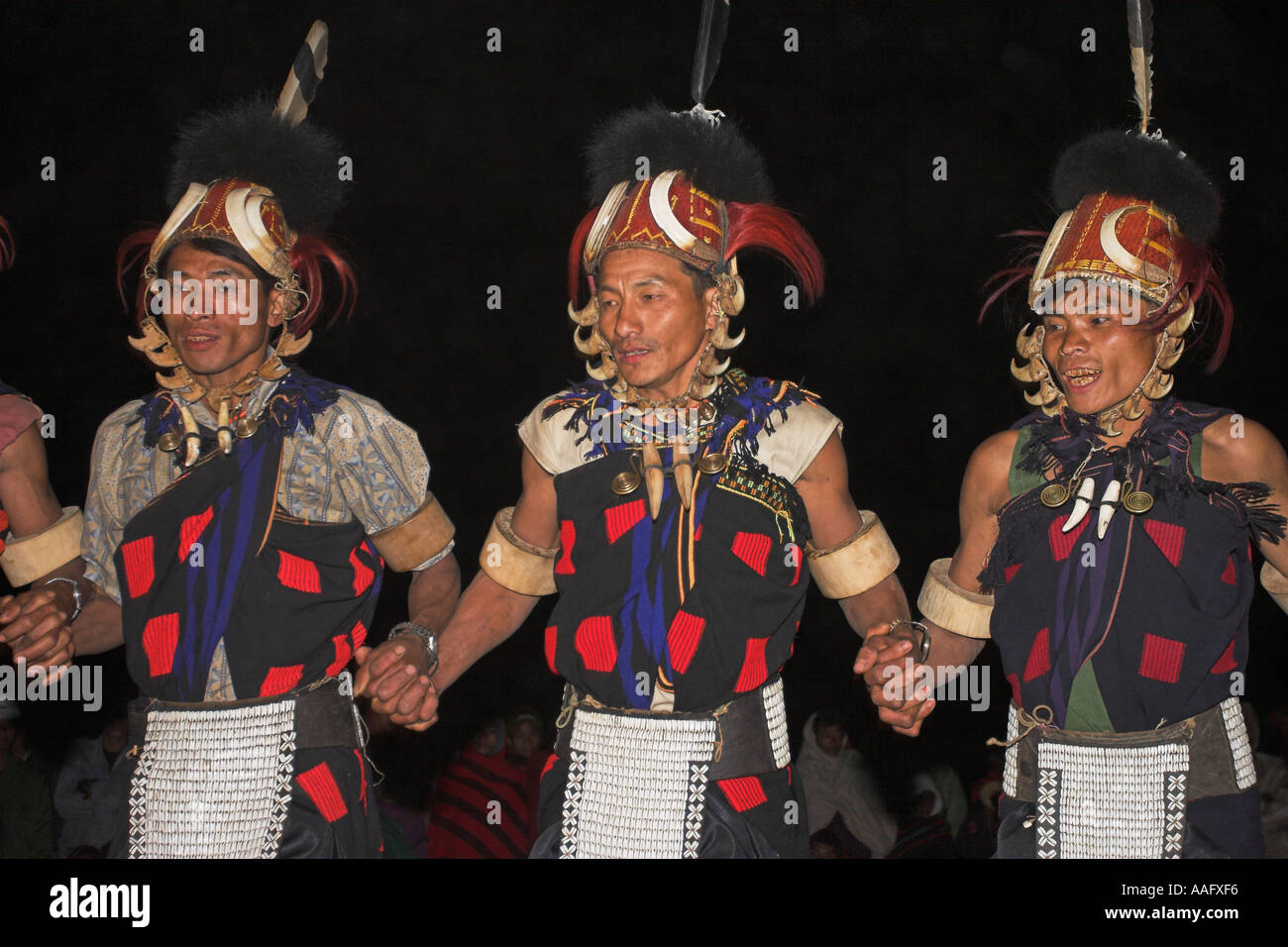 MYANMAR Naga men dancing wearing headdress with wild boar teeth bear ...