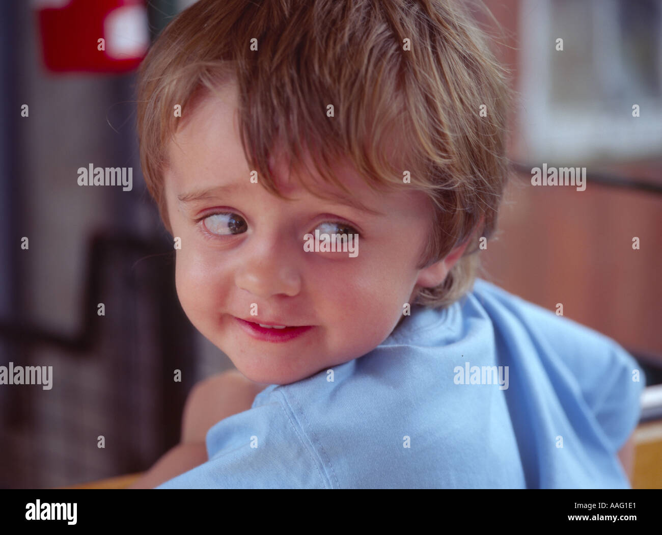 boy looking behind cheeky smile Stock Photo - Alamy