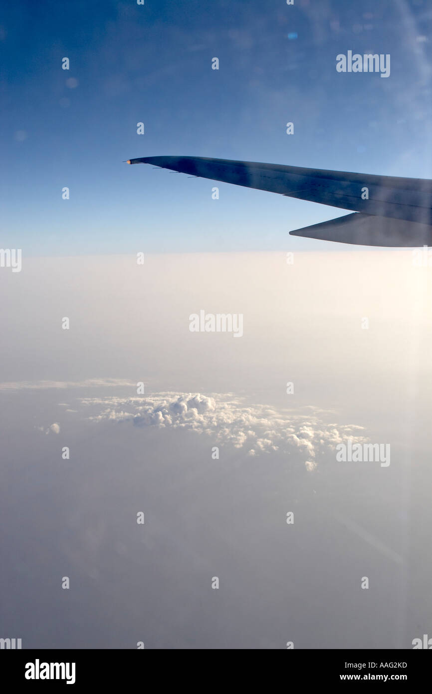 Aerial view from above of towering cumulus penetrating through cloud layer Stock Photo - Alamy