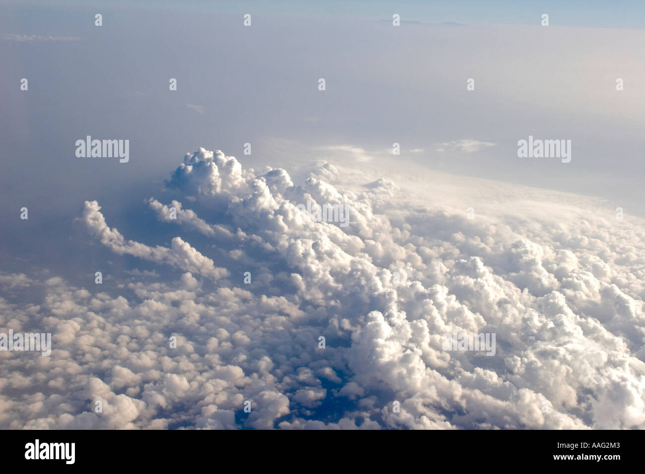 Aerial view from above of towering cumulus penetrating through cloud ...