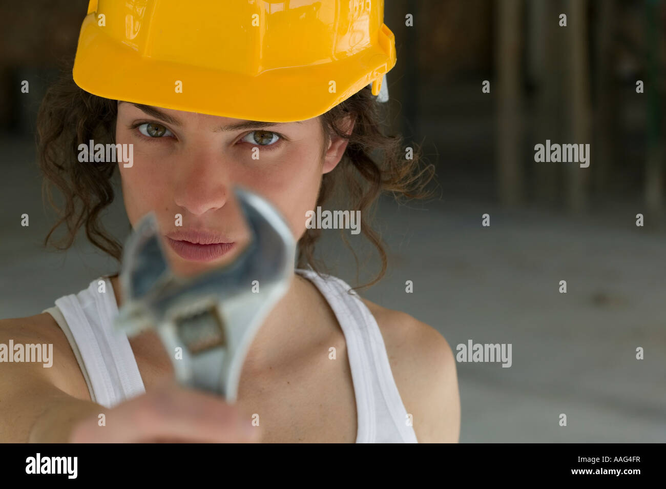 Female construction worker with adjustable wrench Stock Photo - Alamy