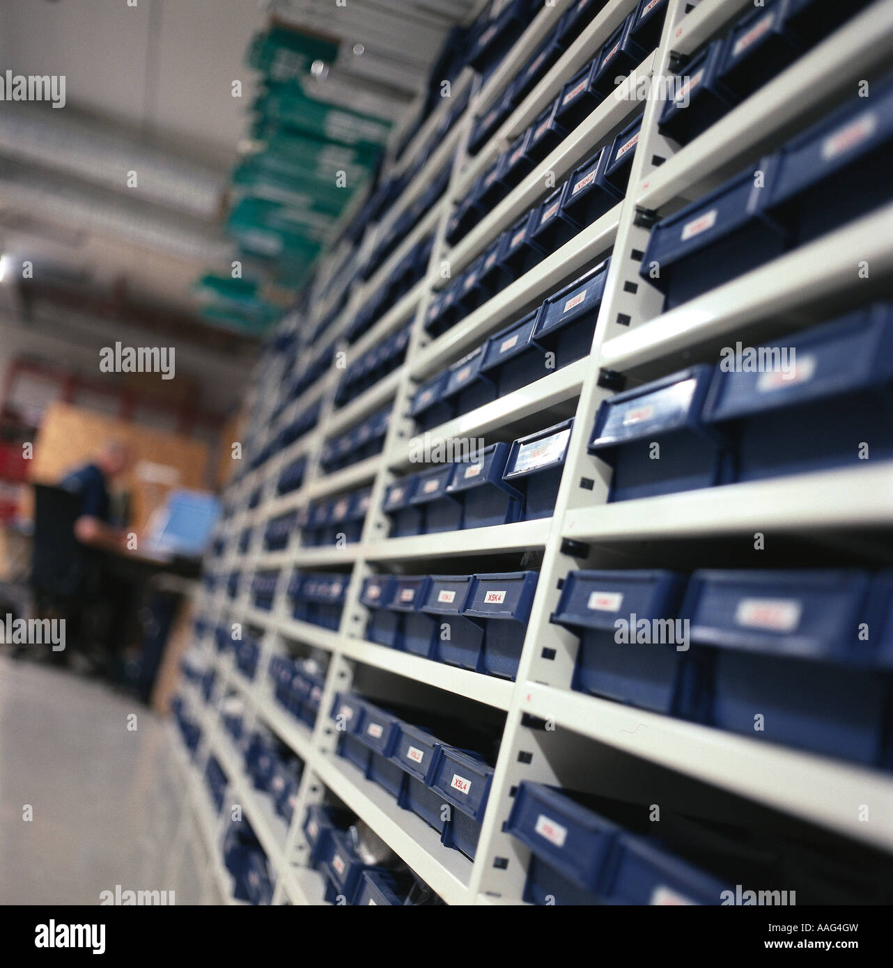 Blue part bins on a white rack Stock Photo - Alamy