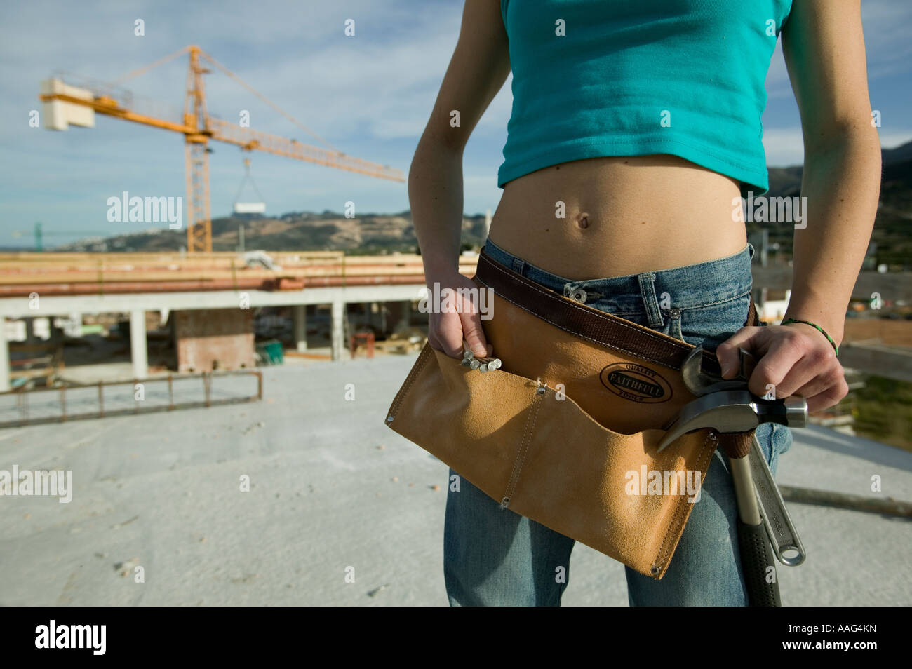 Female construction worker with bare waist on roof of building Stock ...