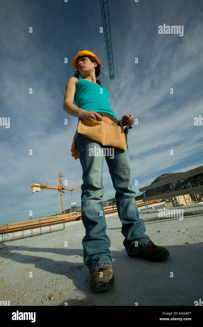 Female construction worker standing on roof of building Stock Photo - Alamy