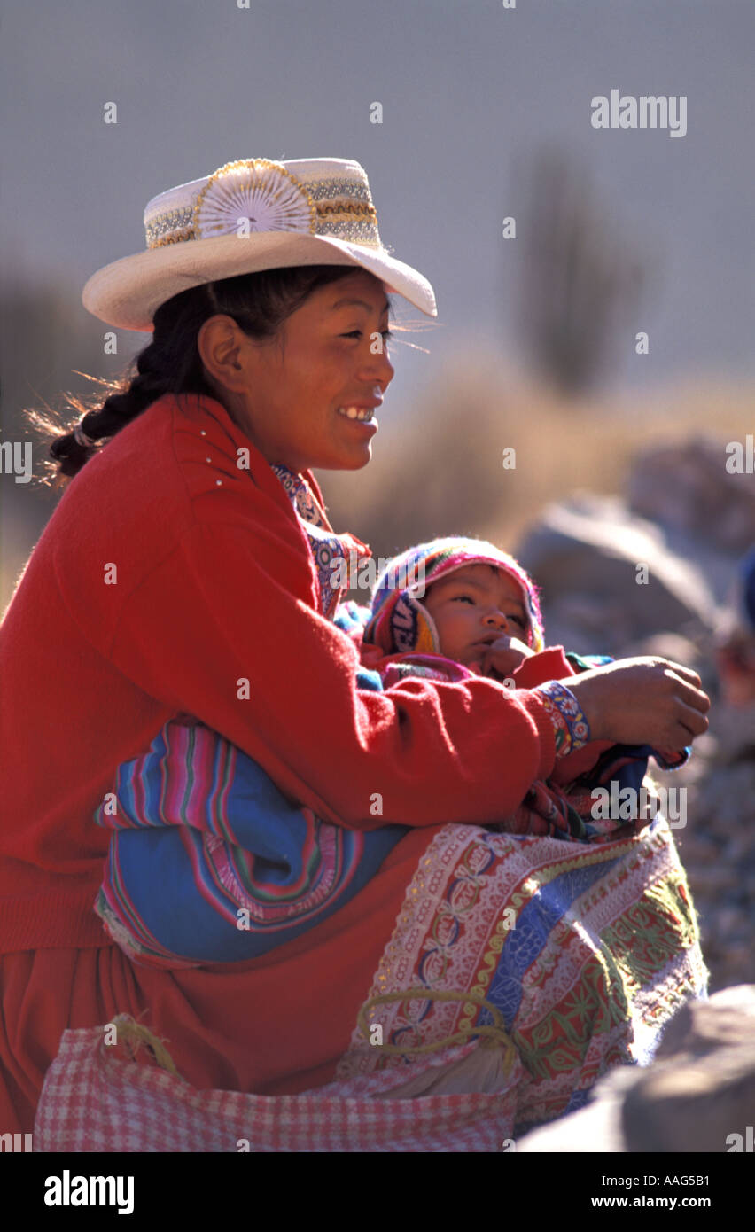 Peruvian mother in distinctive tribal costume selling souvenirs at a ...