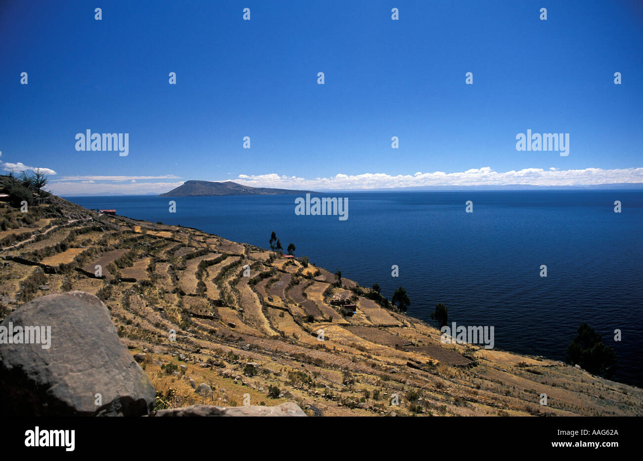 Agricultural terraces on Taquile island The still blue waters of Lake ...