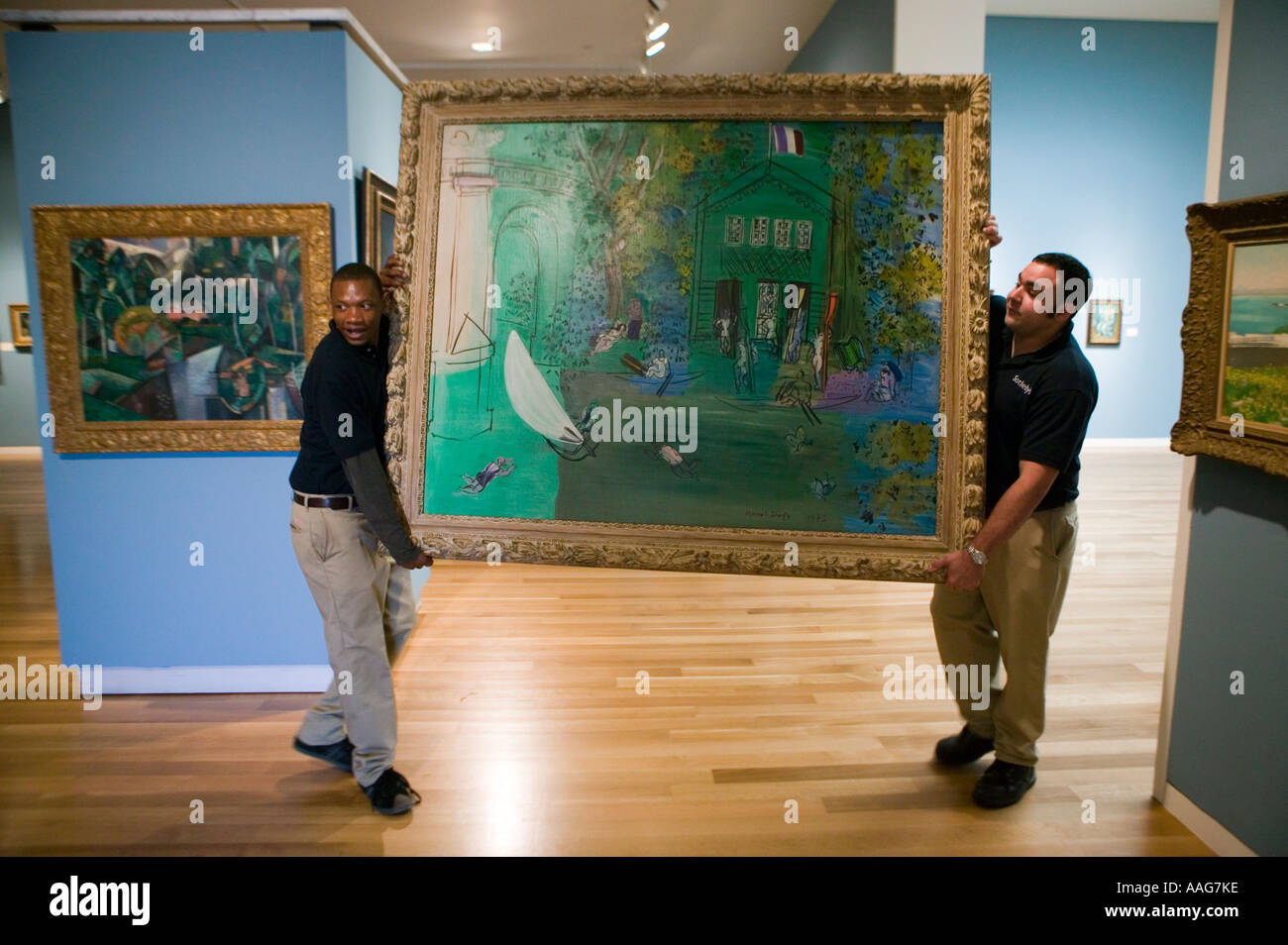 Workers carry a Raoul Duffy painting during preview of Impressionism ...