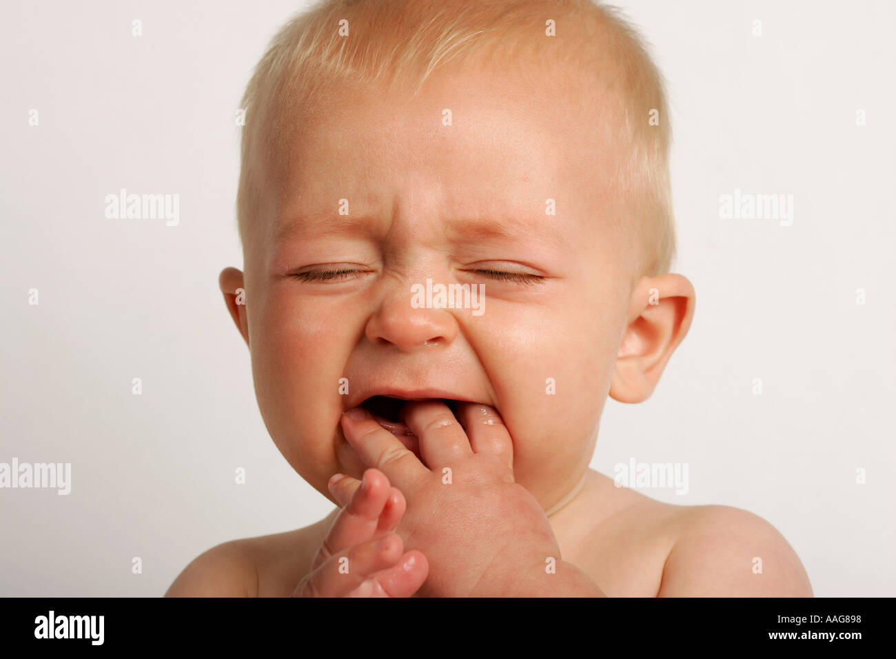 Crying six month old baby bot teething Stock Photo - Alamy