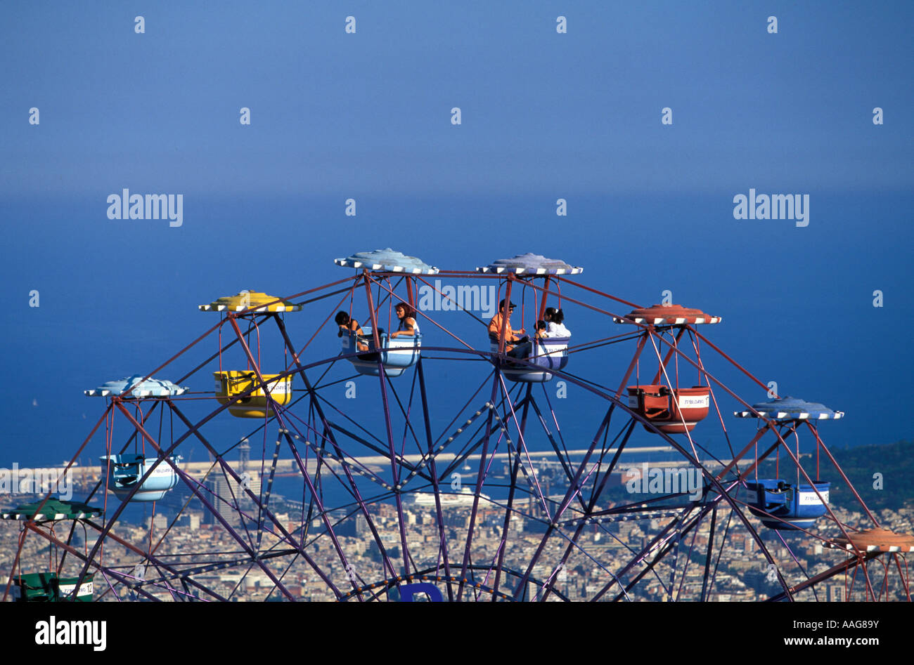 People in ferris wheel enjoying view over Barcelona Parc d atraccions ...