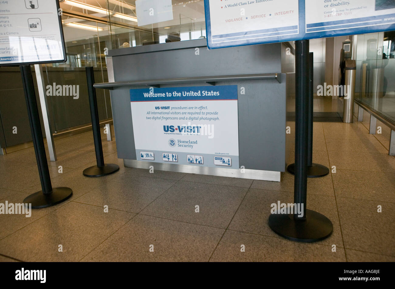 View of a US Visit sign on a passport control booth at Terminal 4 of ...