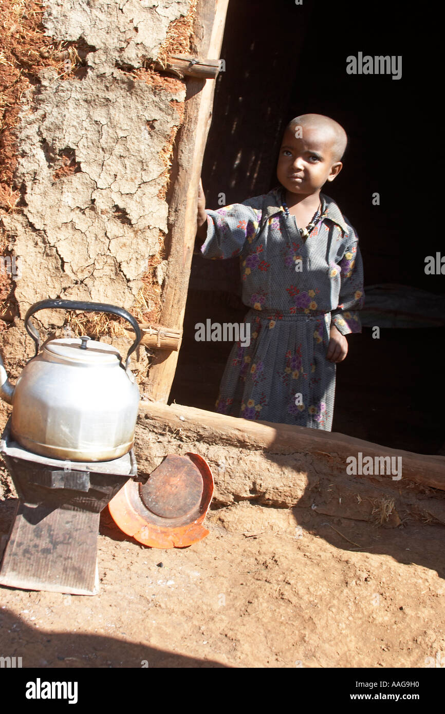Young boy child looking around a door in Kuch village Ethiopia Africa ...