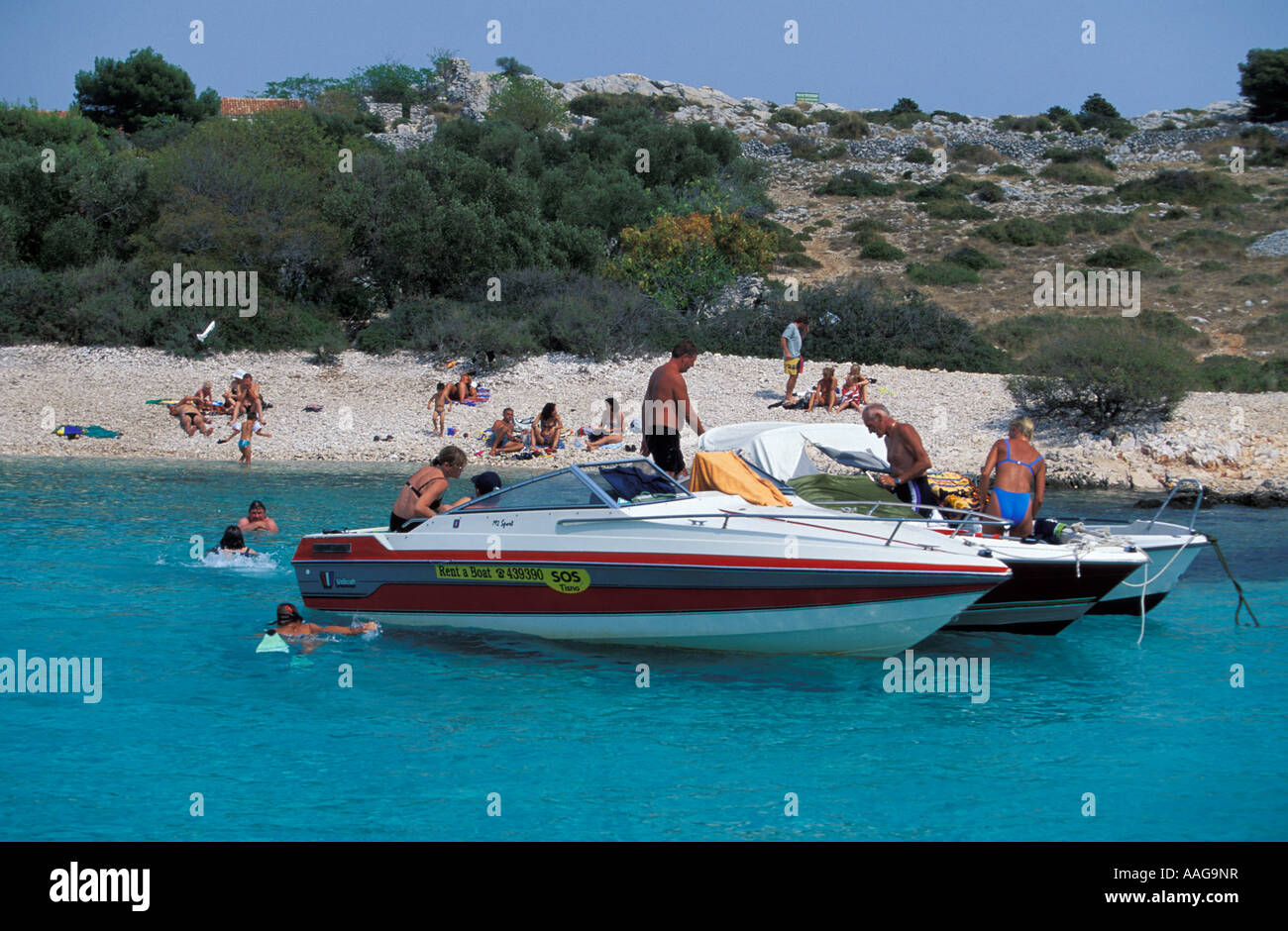 Tourists on boats near beach Levrnaka island Kornati National Park ...
