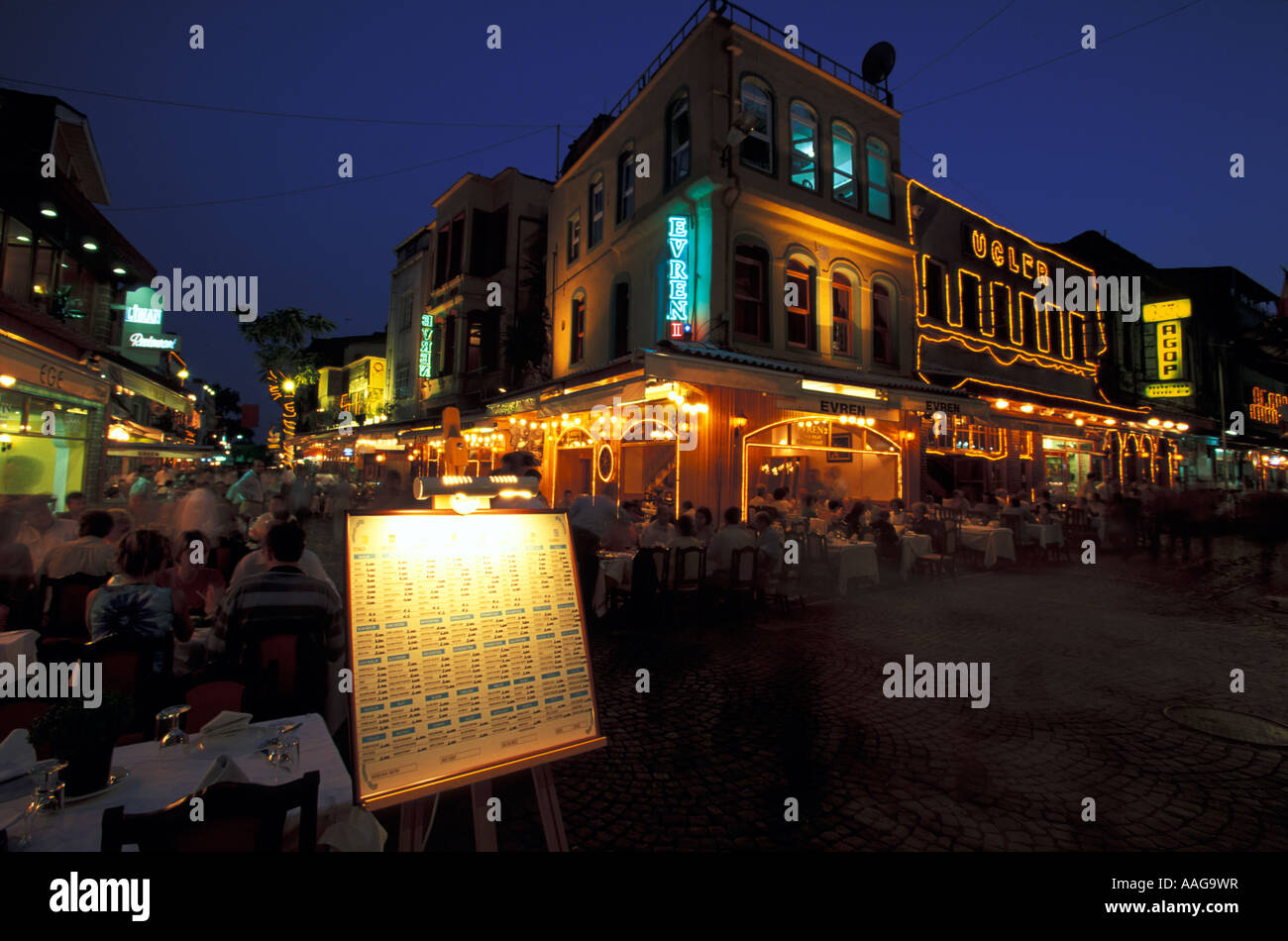 People sitting in the open air area of the fish restaurant Kumkapi in ...