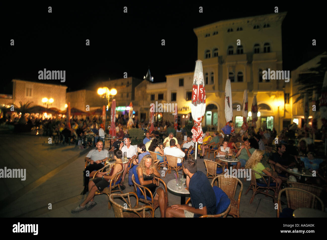 People sitting in pavement cafes at night Trg Municipium Arba Rab Rab ...