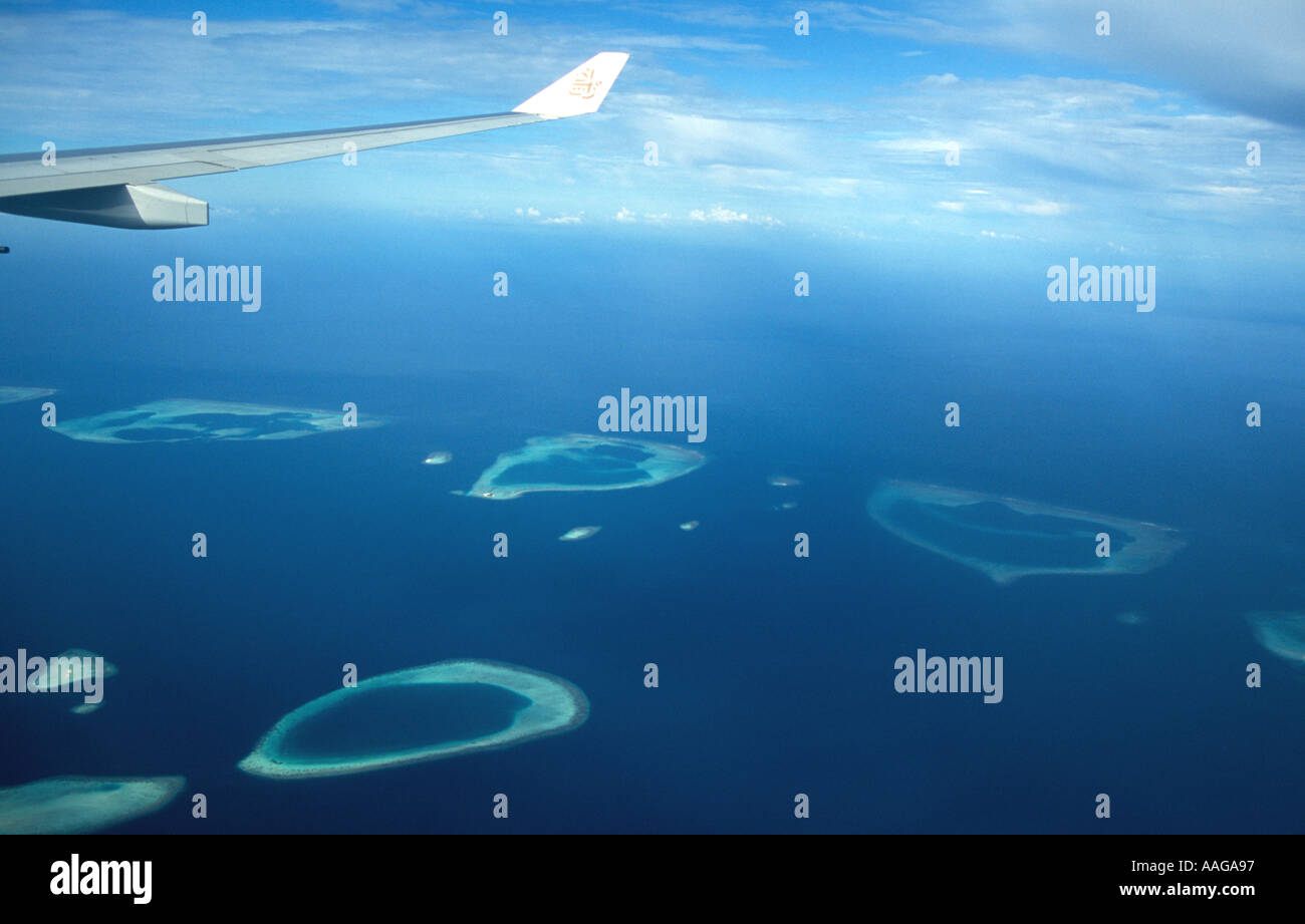 Aerial view of reefs in North Male Atoll Maldives with wingtip of ...