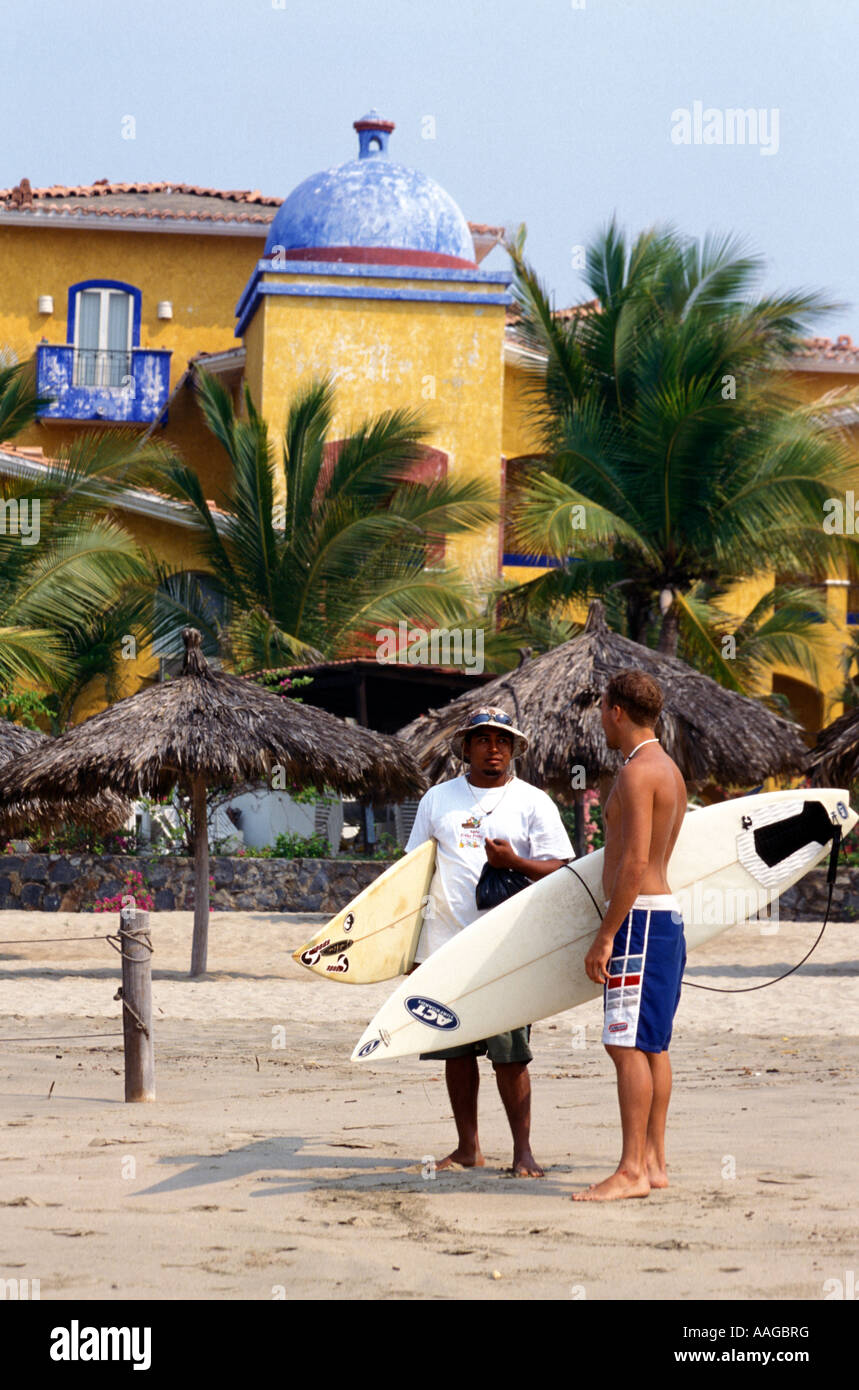 Two surfers at sandy beach of Ixtapa Guerrero Mexico Stock Photo - Alamy