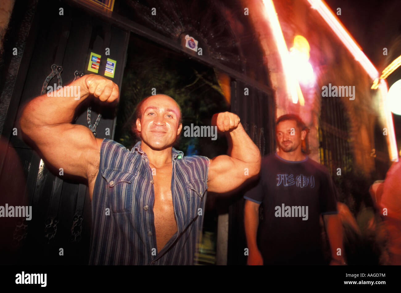 Bouncher flexing biceps standing in front of a club at night Marmaris ...
