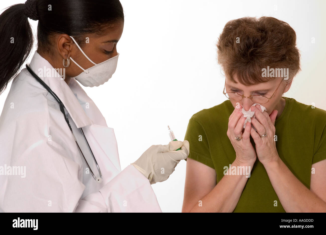Healthcare Worker Examines Sneezing Female Patient USA Stock Photo - Alamy