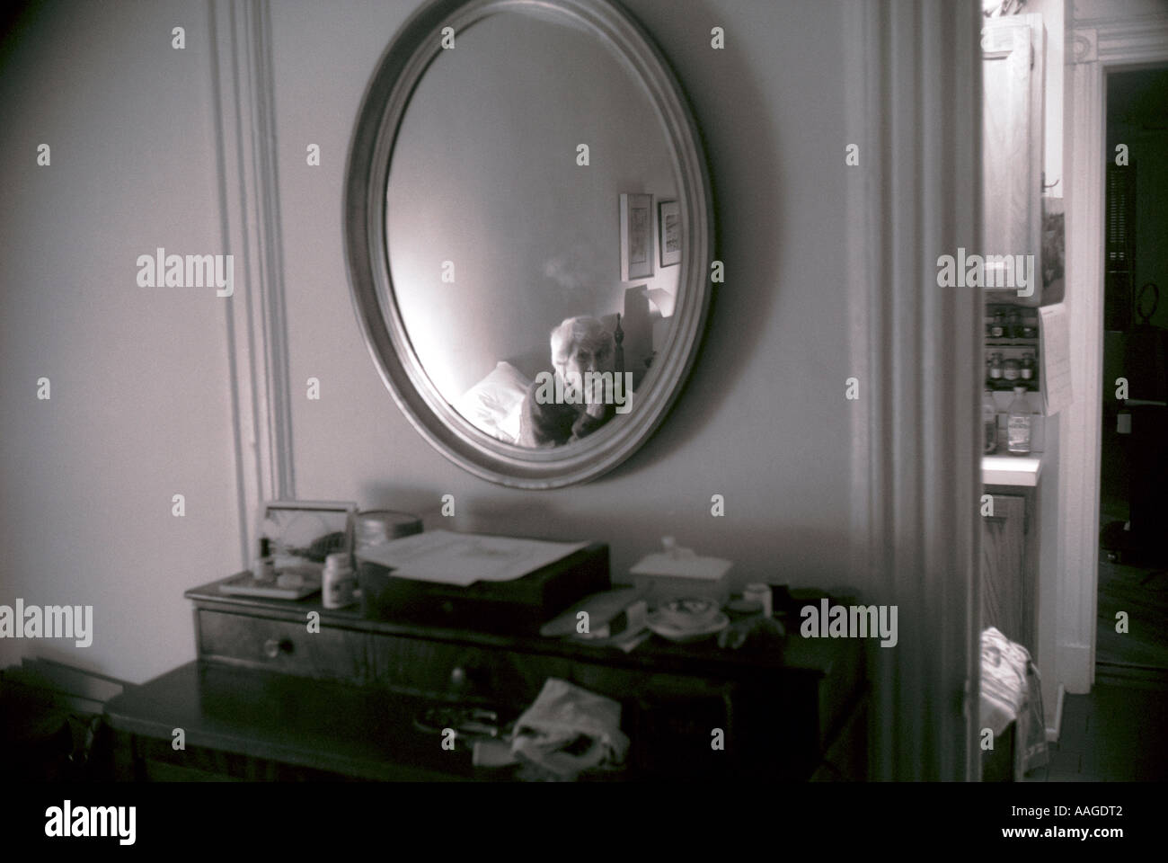 Reflection of senior citizen smoking in her bedroom Stock Photo - Alamy