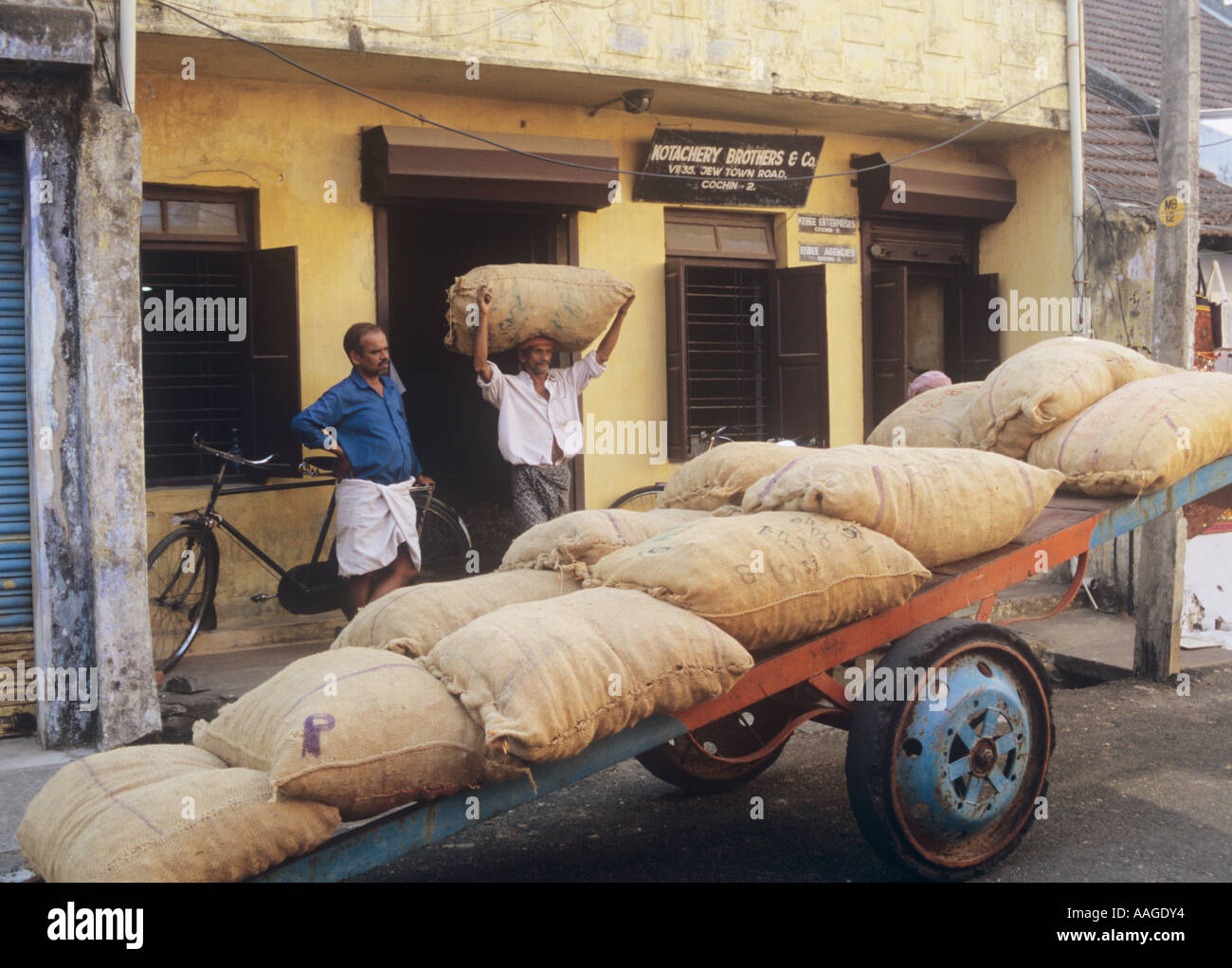 Man loading sacks of spices Jew Town Cochin Kerala India Stock Photo ...