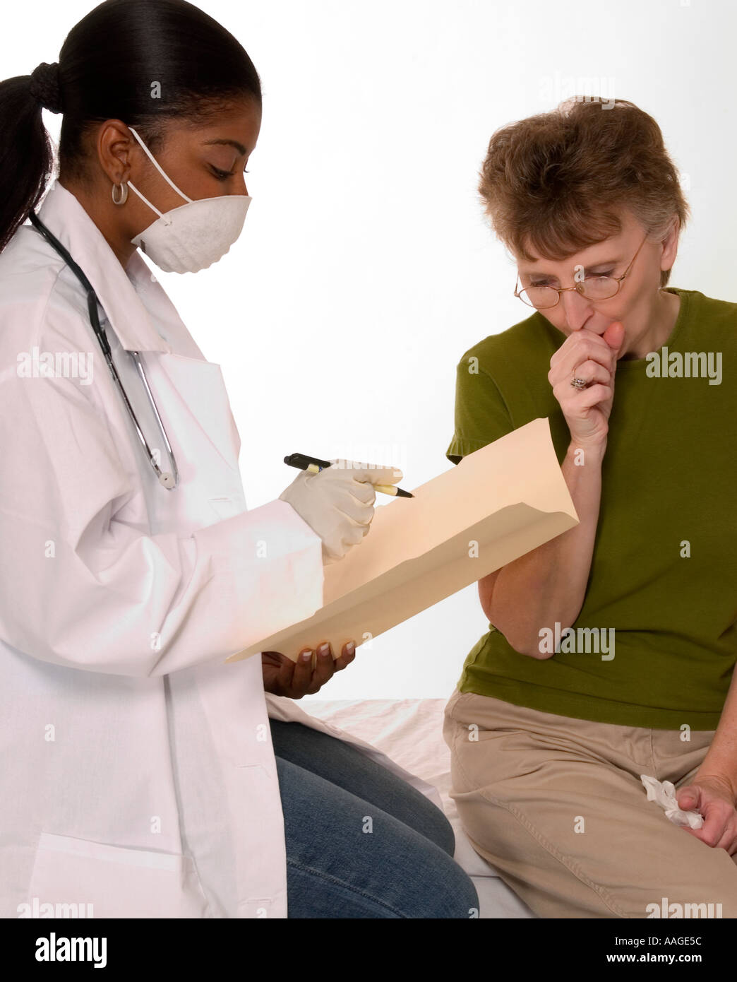 African American doctor discussing medical chart with Caucasian female ...