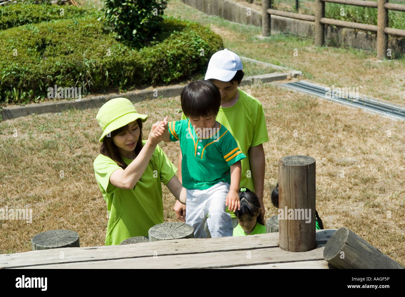 Family playing in playground Stock Photo - Alamy