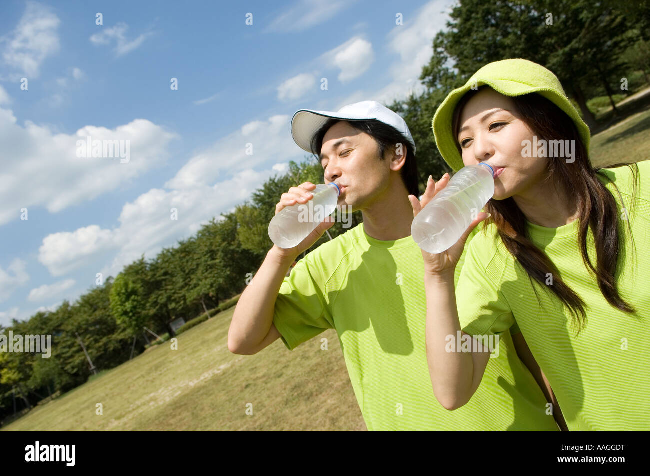 Husband and wife drinking water Stock Photo - Alamy