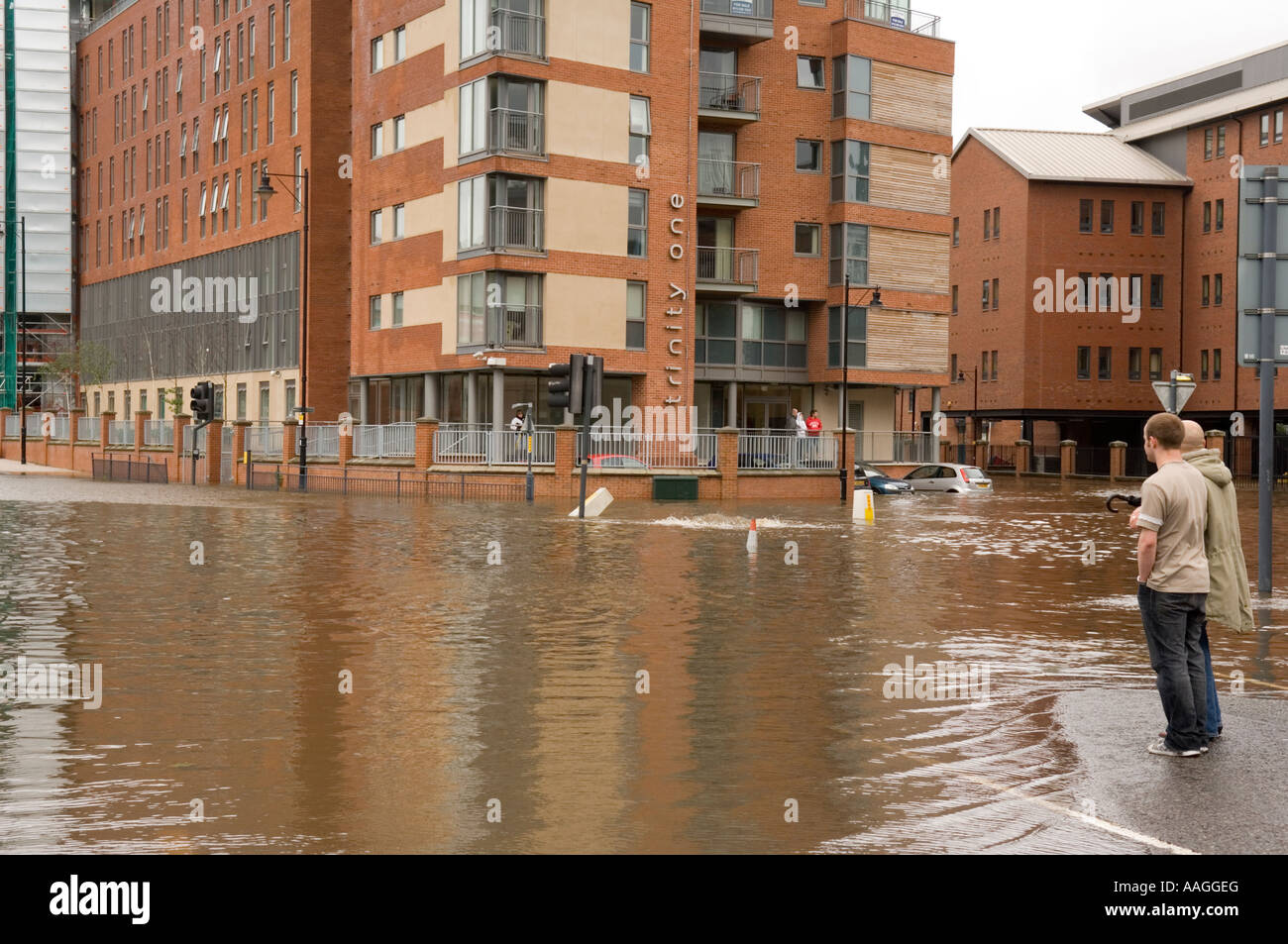 Flooded River Aire onlookers at Neptune Street & East Street Leeds with ...
