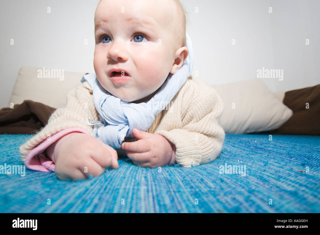 Baby Lying on Sofa Stock Photo - Alamy